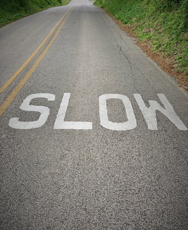 Slow sign on road stock image. Image of asphalt, sign - 184376333