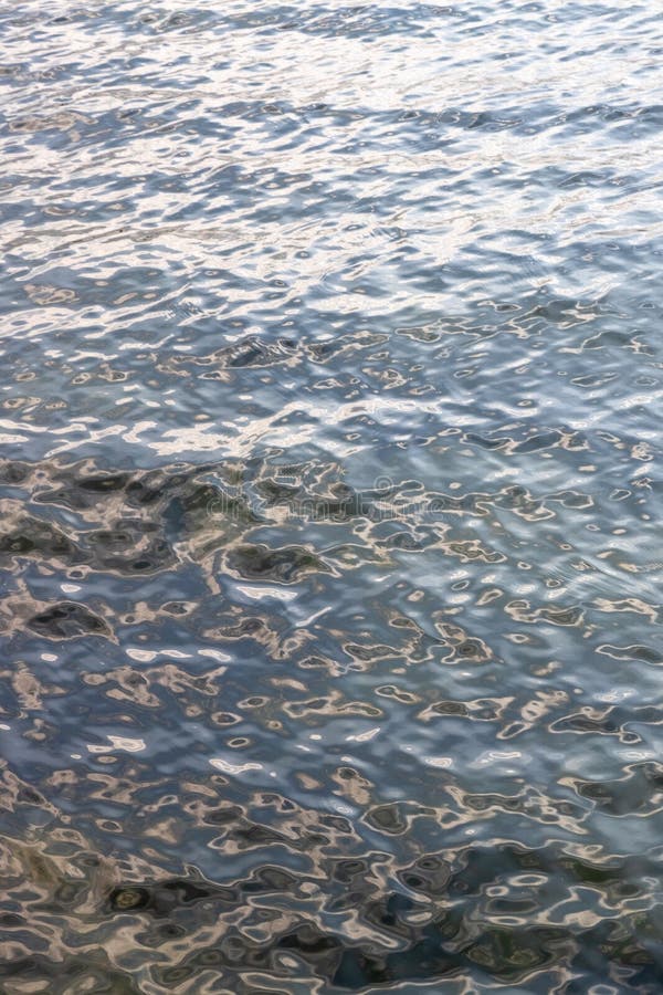 Slowly Moving Littles Waves on Water with Reflections Stock Image ...