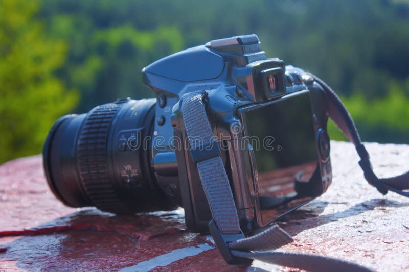 SLR Camera Lies on a Stone on a Blurred Background of Nature Close-up ...