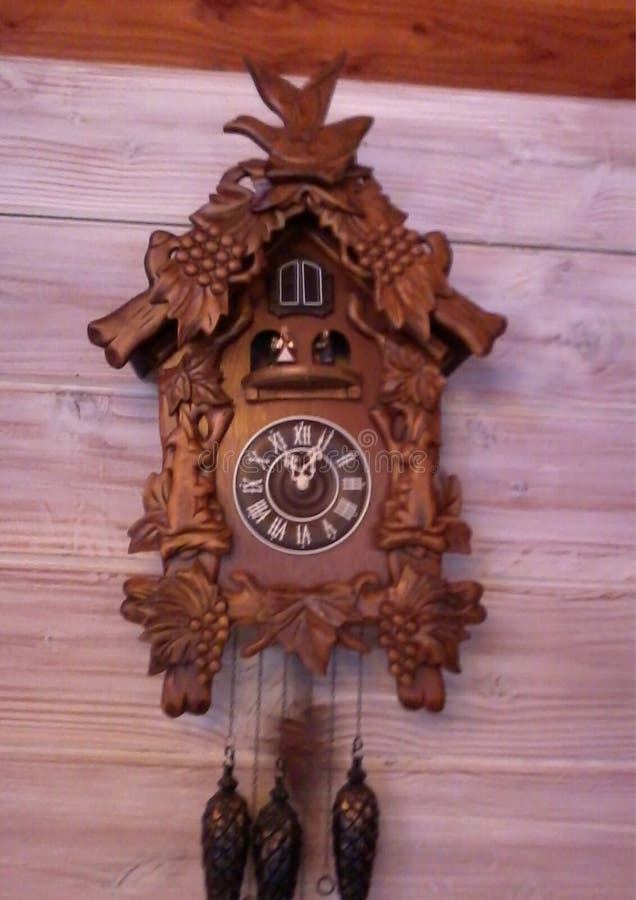 Ornate Wooden Cuckoo Clock with Intricate Carvings of Leaves and Grapes ...