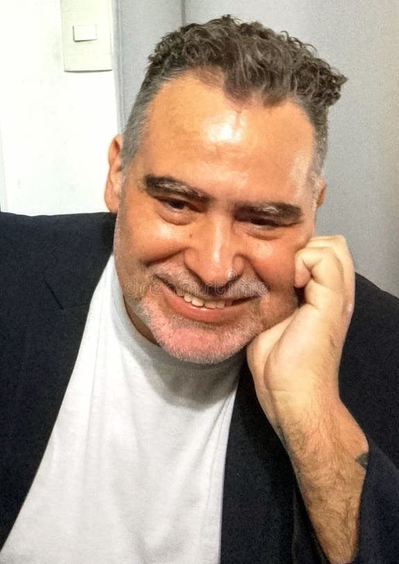 Middle-aged Man Smiling with His Head Slightly Tilted Down and One Hand ...