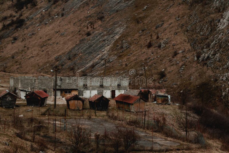 Small Abandoned Huts with a Destroyed Building and Mountainside in the ...