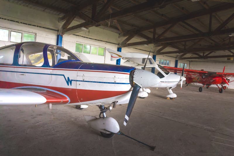 Small aircraft in a hangar stock photo. Image of pilot - 95009168