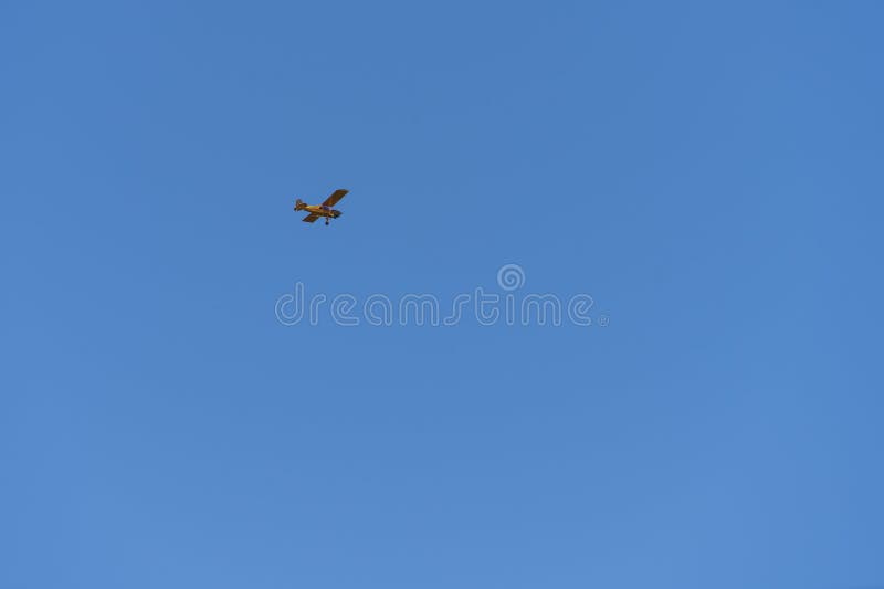 Small Airplane Flying Against a Clear Blue Sky Stock Image - Image of ...