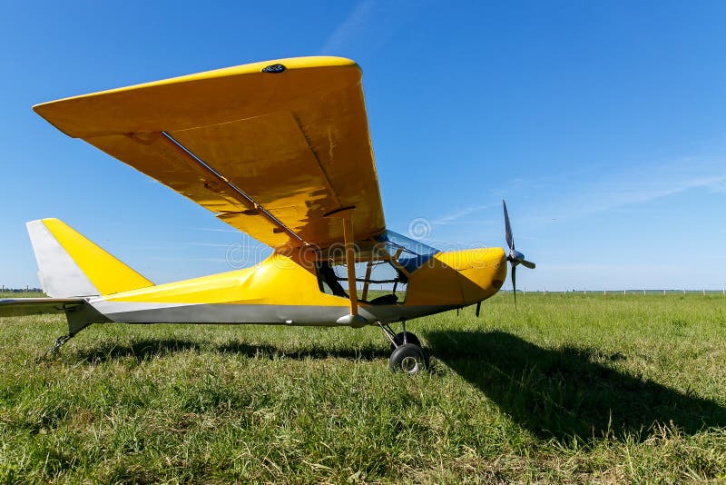 Small Airplane Waiting on Field, Yellow Plane on the Grass. Stock Image ...