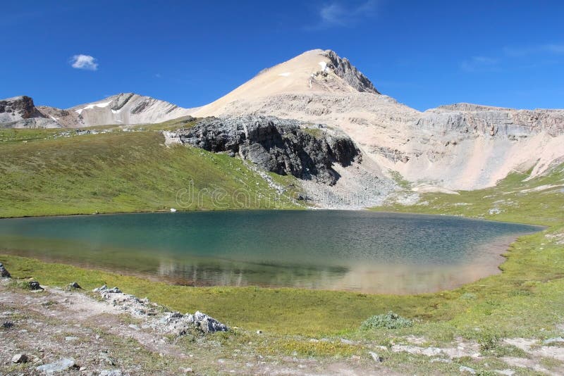 Small Alpine Lake with Mountain in Background Stock Image - Image of ...