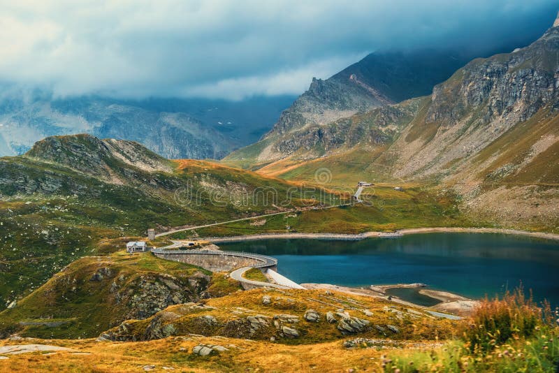 Small Alpine Lake among Mountains Under Cloudy Sky in Italy Stock Image ...
