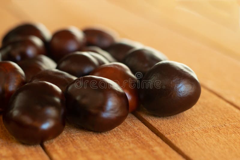 A Small Amount of Chestnuts Lying on a Wooden Plank Surface Stock Photo ...
