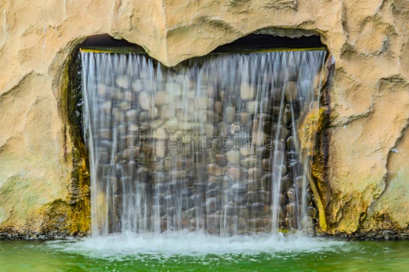 Small Artificial Waterfall in Man Made Tropical Garden. a Small ...