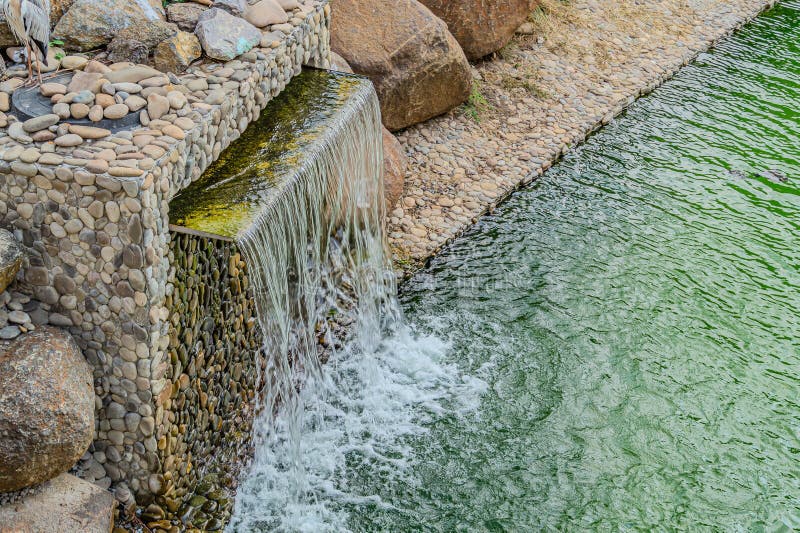 Small Artificial Waterfall in Man Made Tropical Garden. a Small ...