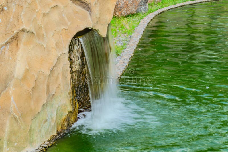 Small Artificial Waterfall in Man Made Tropical Garden. a Small ...