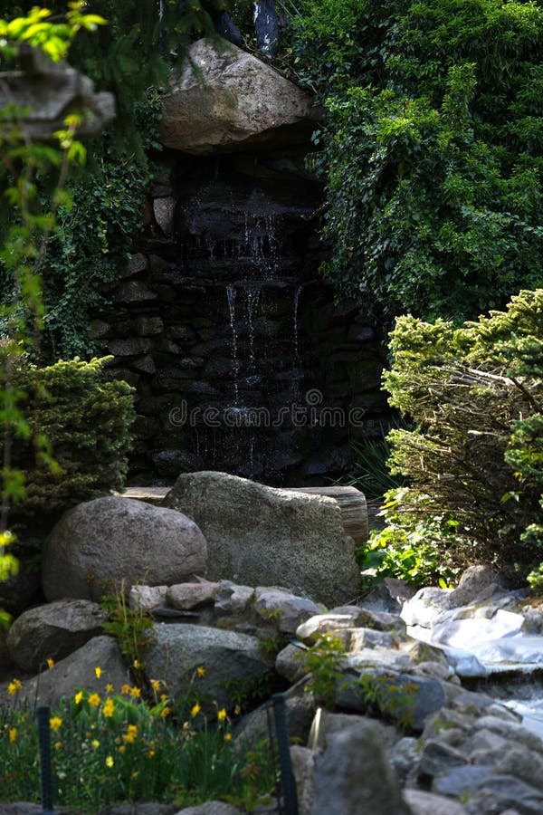 A Small Artificial Waterfall among the Rocks in the Landscape Design of ...