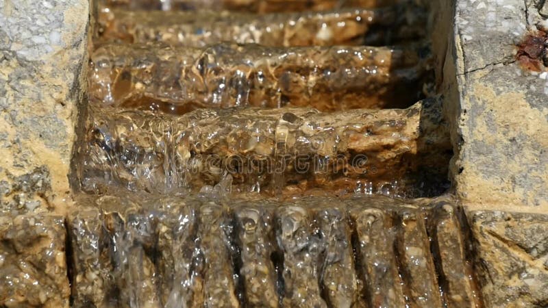 A Small Artificial Waterfall on the Rocks in the Park, Constant Running ...