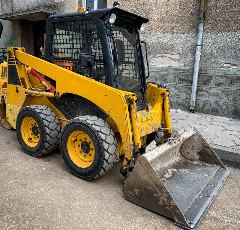 Small Backhoe Loader Parked on a Construction Site. Stock Image - Image ...