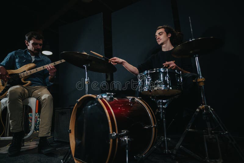 Musicians Rehearsing with Bass Guitar and Drums in a Dimly Lit Studio ...