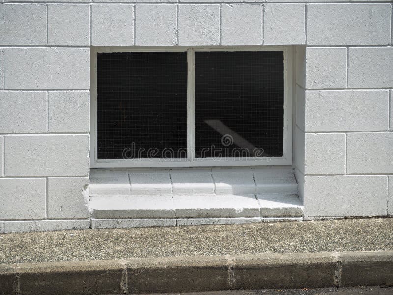 Small Basement Window with Security Mesh on White Brick Wall Stock ...