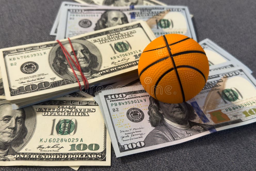 Small Basketball on Stack of Dollars. High Quality Photo Stock Photo ...