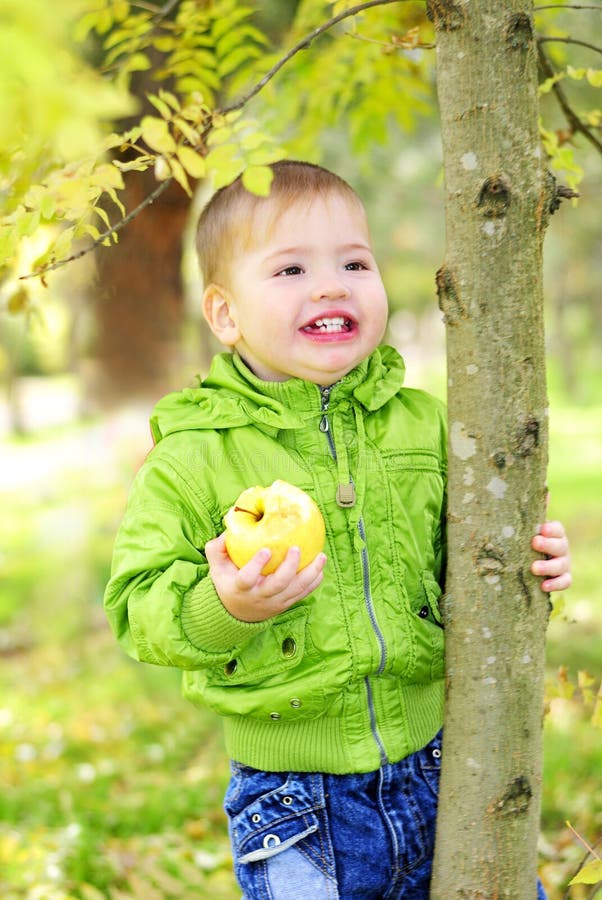 The Small Beautiful Boy Walks on a Green Glade Stock Photo - Image of ...