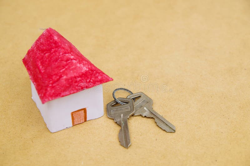 A Small and Beautiful House Model Made of Paper with a Couple of Keys ...