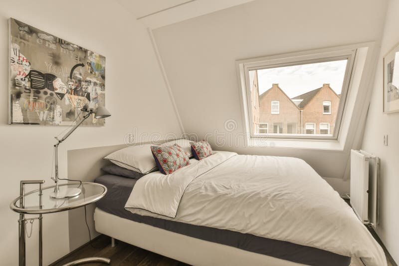 A Small Bedroom with a Bed and a Window Editorial Photo - Image of ...