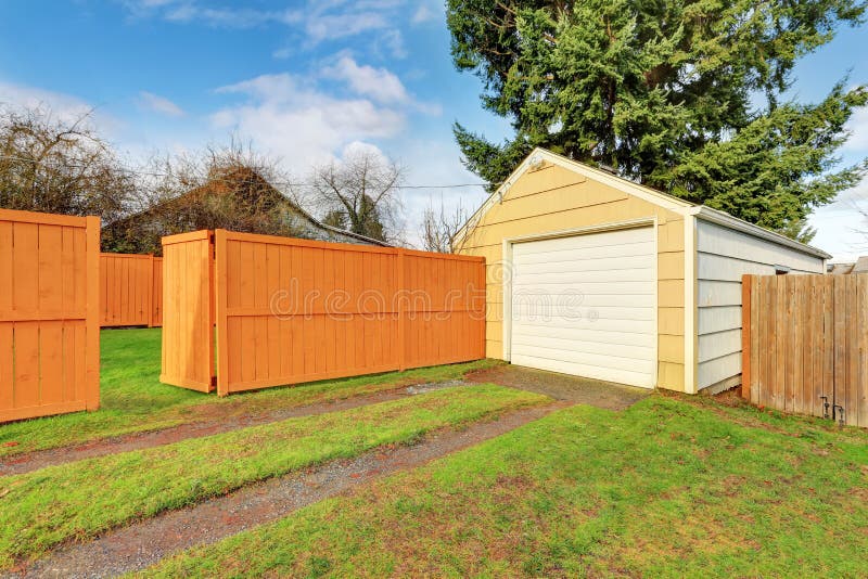 Small Beige Detached Garage at the Fenced Backyard Stock Photo - Image ...