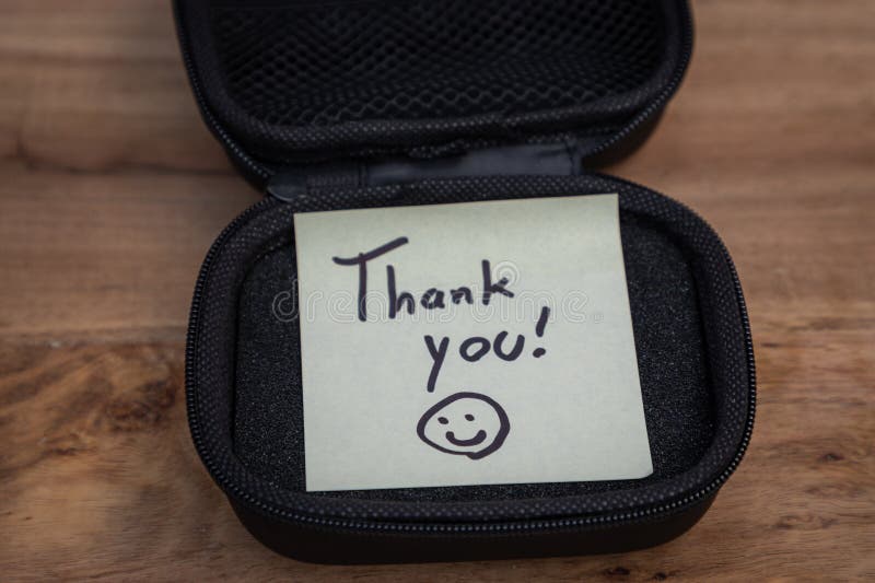 A Small Black Box with a Smiley Face and Thank You Sticker on it Stock ...