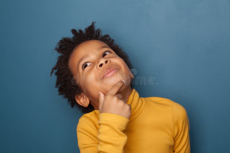 Small Black Child Boy Thinking and Looking Up on Blue Background Stock ...