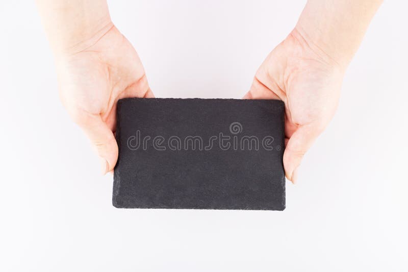 A Small Black Black Slate Plate is Presented by Hands Stock Photo ...