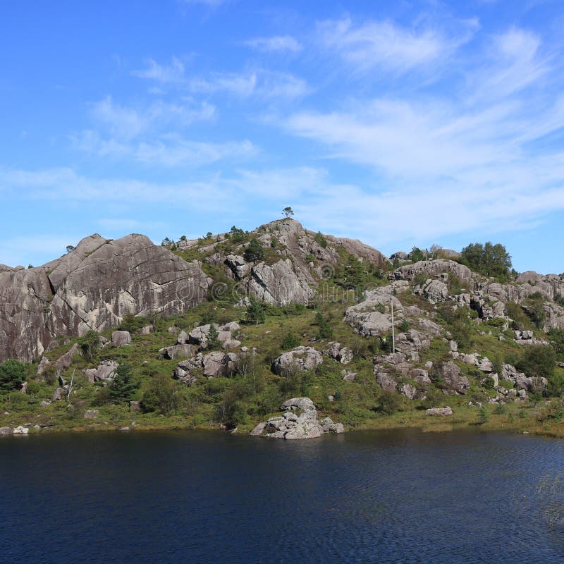 Small Blue Lake and Single Tree Growing on Top of a Rocky Hill, Hellvik ...