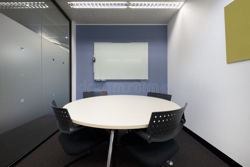Small Boardroom with White Round Circular Table and Whiteboard with ...