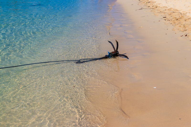 Small Boat Anchor on Shore of Ocean Stock Image - Image of clear ...
