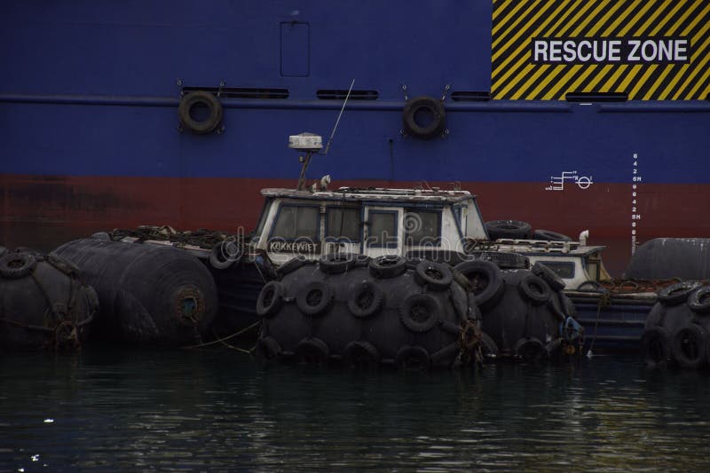 Small Boat in Harbor with Large Ship Editorial Stock Image - Image of ...