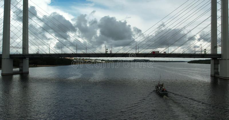 A Small Boat on the River with a Bridge in the Background. Stock Video ...