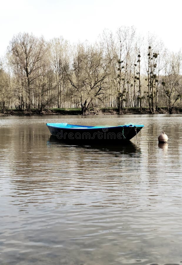 A small boat on a river stock image. Image of blue, boat - 214578177