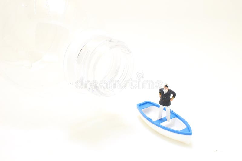 A Small Boat with the Tiny Figure Captain Stock Photo - Image of figure ...
