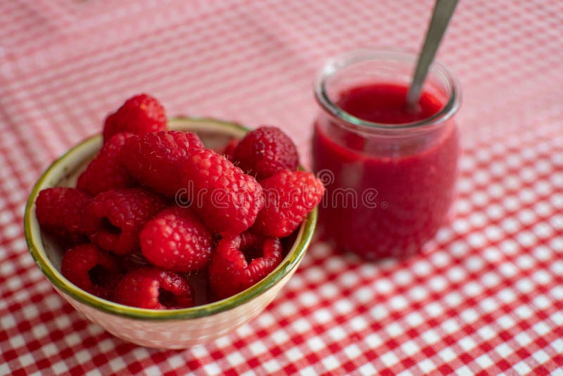 Small Bowl with Fresh Raspberries Next To a Glass with Raspberry Jam ...