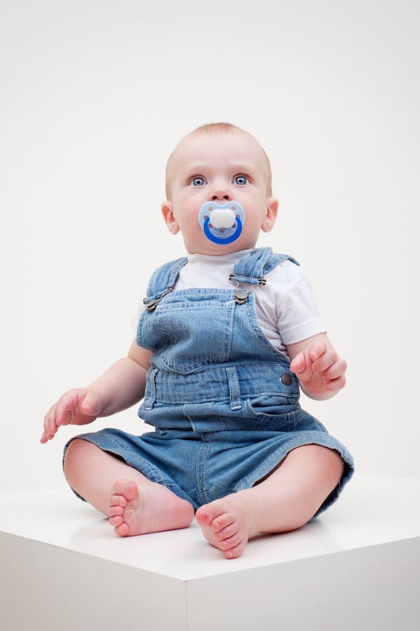Small Boy with Baby S Dummy Stock Photo - Image of looking, dungarees ...