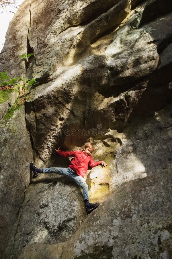 Small Boy Climbing on the Rocks in the Forest Stock Image - Image of ...