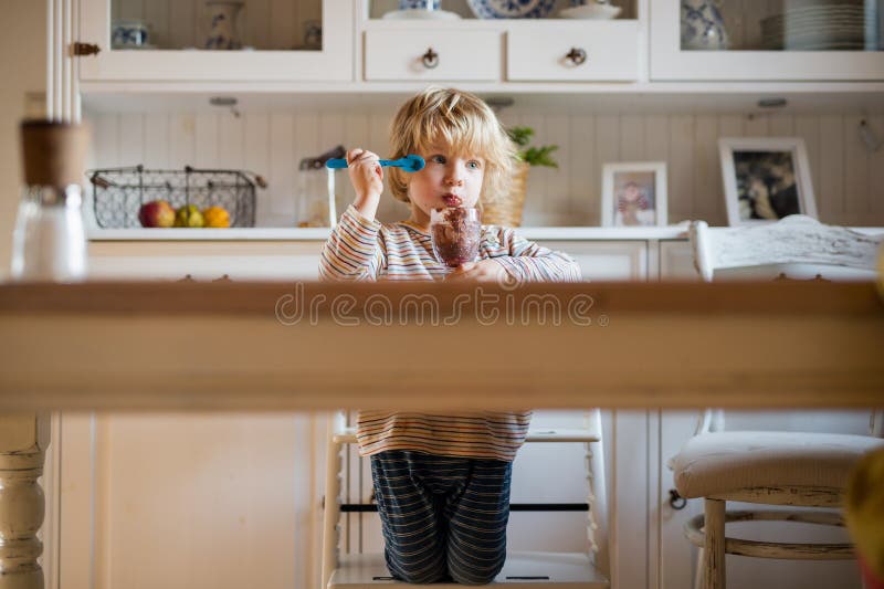 Small Boy with Dirty Mouth Indoors in Kitchen at Home, Eating Pudding ...