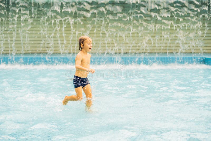 Small Boy Having Fun Runing in Swimming Pool Stock Photo - Image of ...