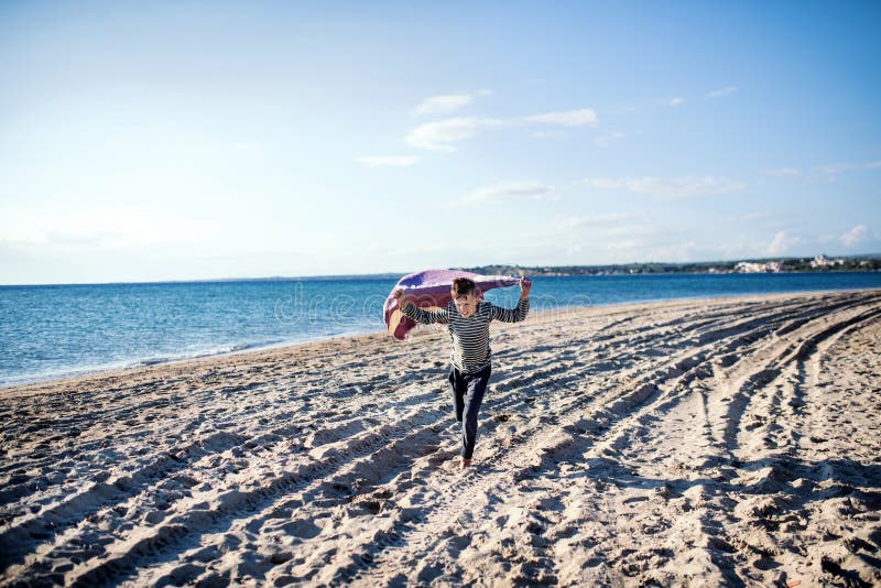 A Small Boy Playing Outdoors on Sand Beach. Stock Photo - Image of ...