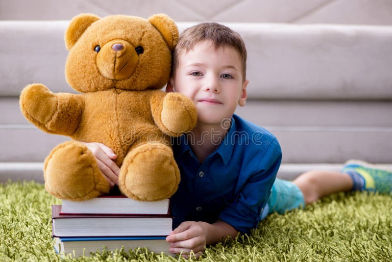 The Small Boy Reading Books at Home Stock Image - Image of lying, book ...
