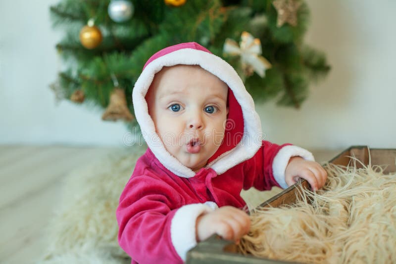 Small Boy in Santa Suit Plays in White Studio Stock Photo - Image of ...