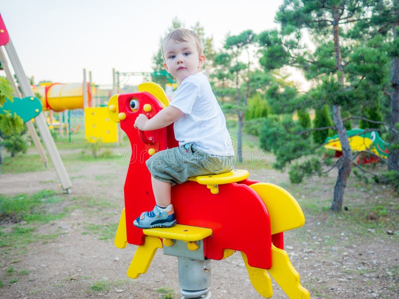 Small Boy Sit on Playground Stock Photo - Image of outside, family ...