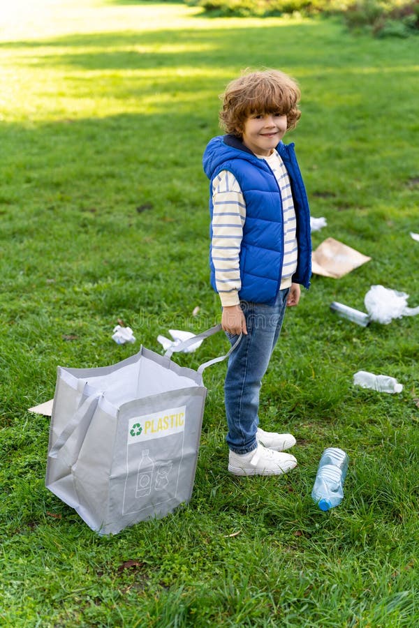 Small Boy Sorting Garbage into Recycle Bags during Community Project ...