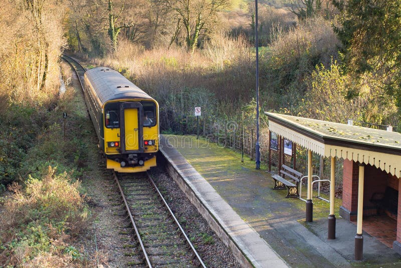 A Small Line of Cars Waiting for a Cargo Train To Pass through the ...