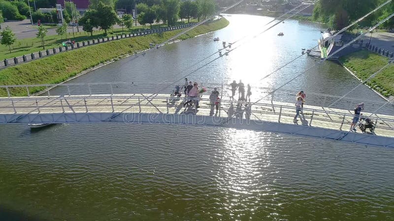 A Small Bridge Across the River, People Walk Across the Pedestrian ...