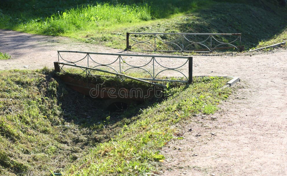 Small Bridge Over a Drainage Ditch in the Park Stock Image - Image of ...