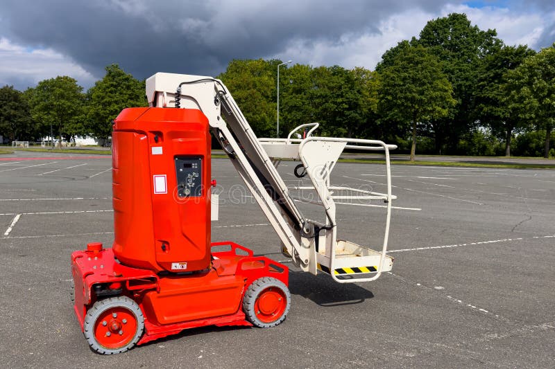 A Small Bright Red Lift for People Standing in an Empty Parking Lot ...