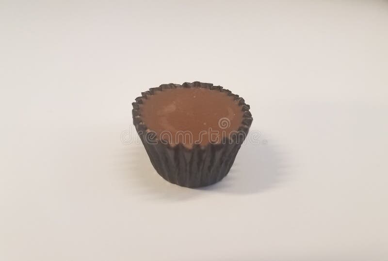 Small Brown Chocolate Candy in Wrapper on White Surface Stock Photo ...